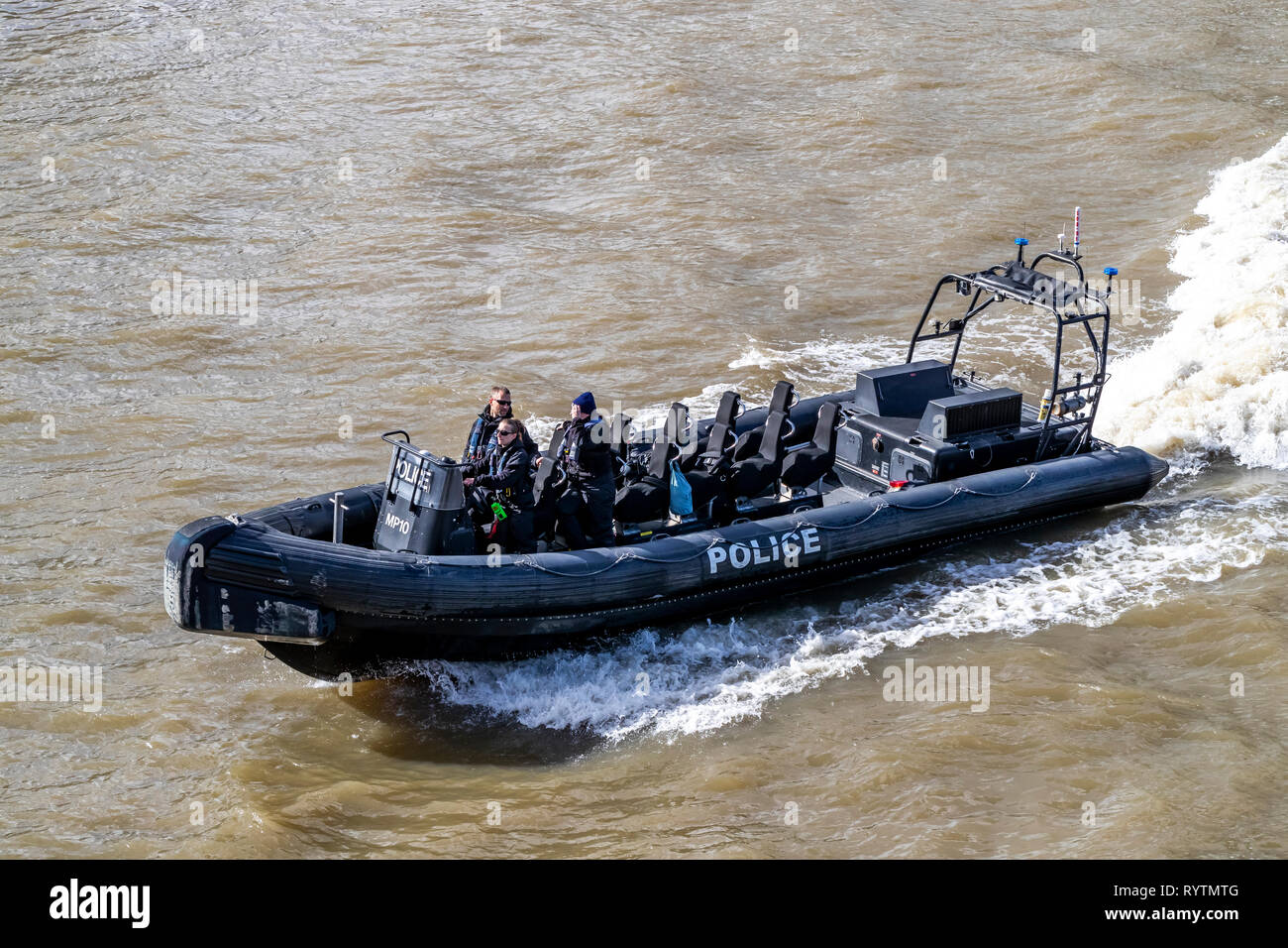 Metropolitan Police river launch on the River Thames at Tower Bridge ...