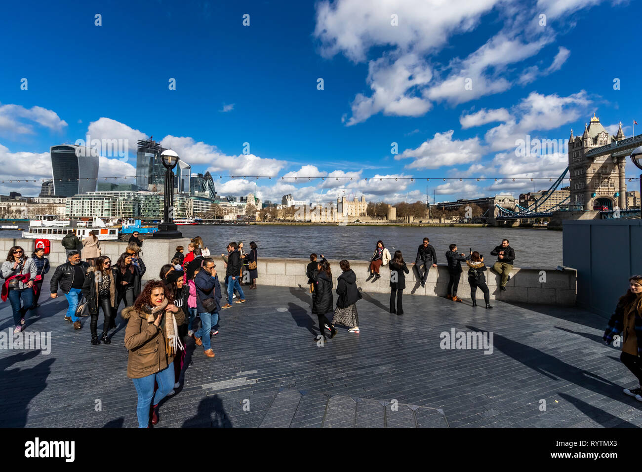 London tourists take pictures and look at Tower Bridge from the Queens ...