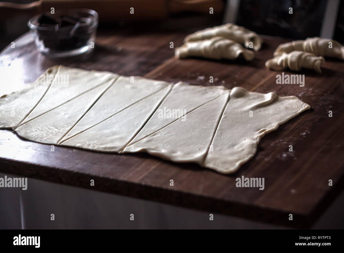 Cut the dough into triangles for croissants with chocolate Stock Photo ...