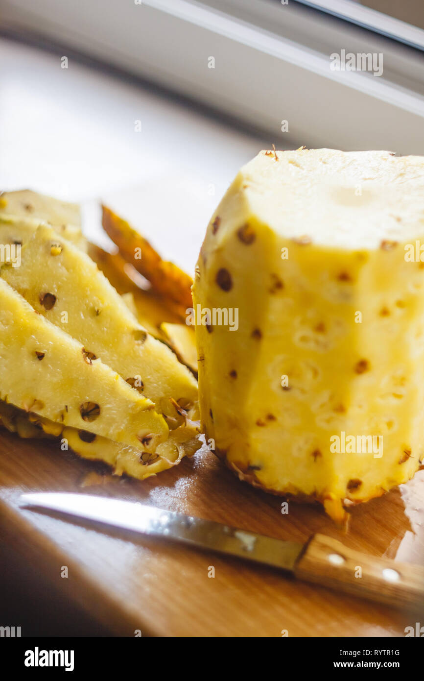Pineapple cleaning, chunks, knife lie on the board Stock Photo - Alamy