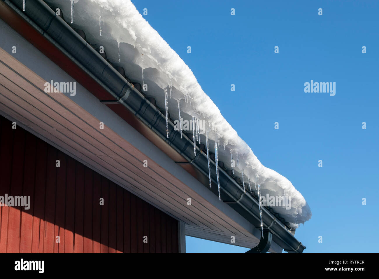 Icicles hanging from house eaves, Finland Stock Photo - Alamy
