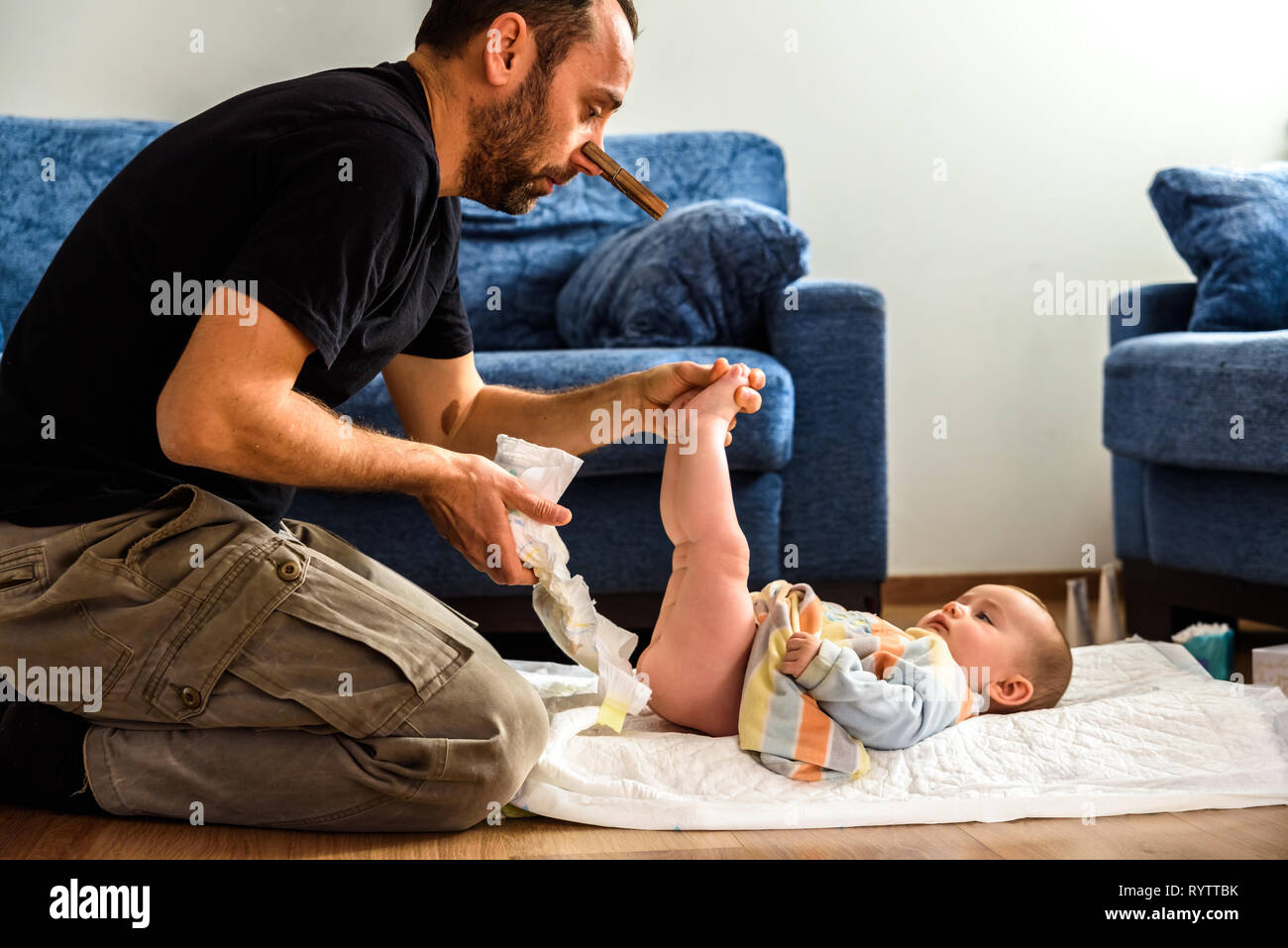 Dad with a pincer on his nose so he does not smell the smell of his ...