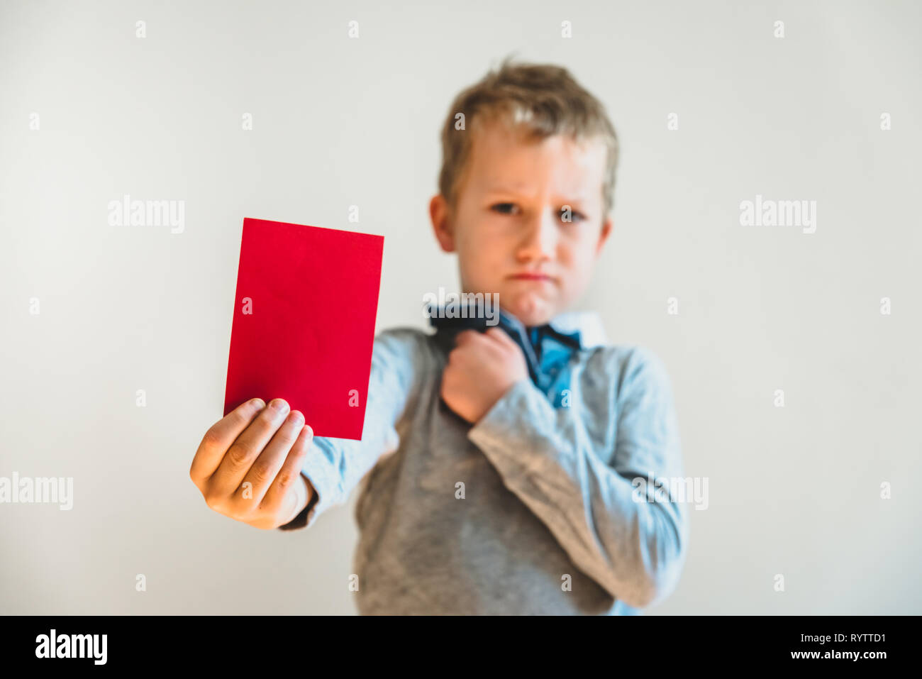Scared child with red anti bullying card Stock Photo - Alamy