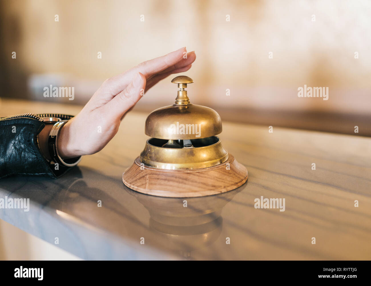 Hand ringing service bell on hotel reception desk Stock Photo - Alamy