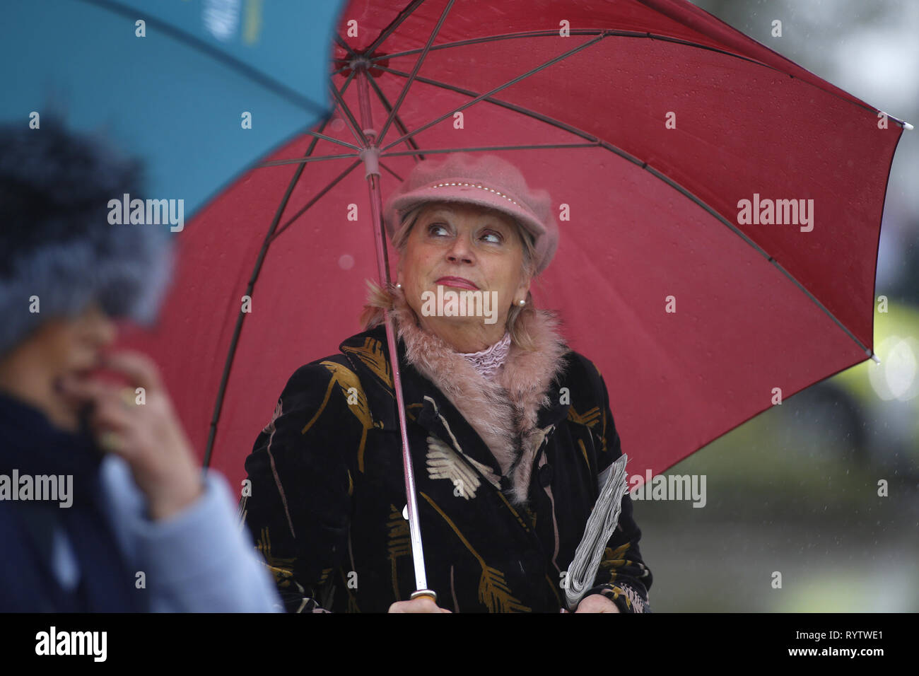 Racegoers arrive in the rain during Gold Cup Day of the 2019 Cheltenham ...