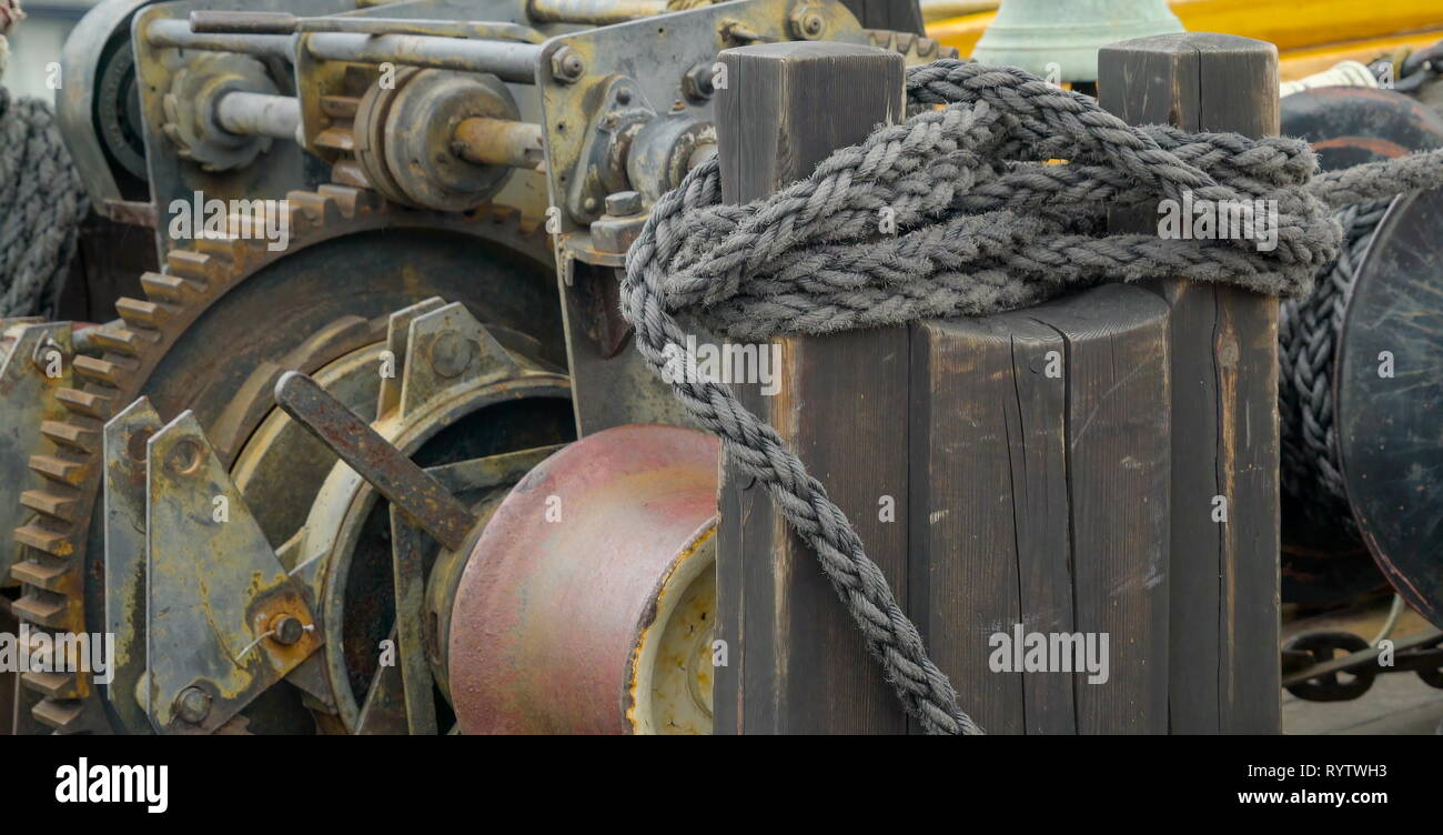 A metal motor inside the ship vessel its a big metal with lots of rope ...