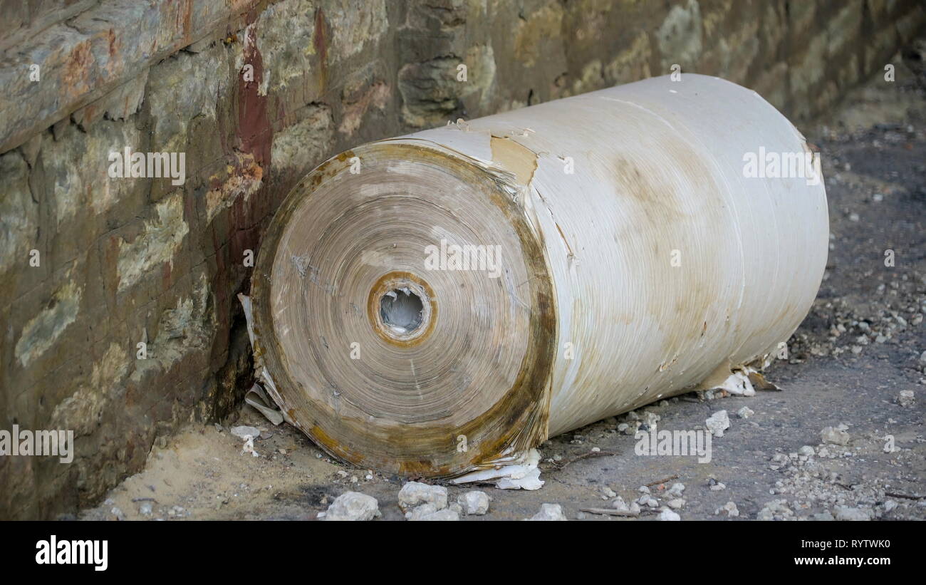 Big rolls of paper sheets on the floor it is an old paper rolls found ...