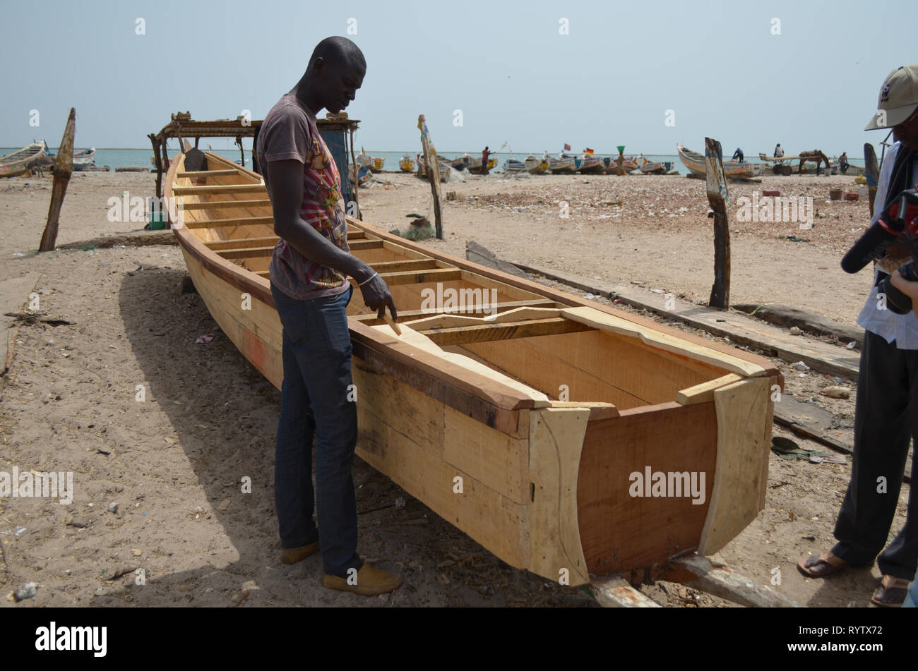 Carving an artisanal wooden pirogue in Senegal’s Petite Cote Stock ...
