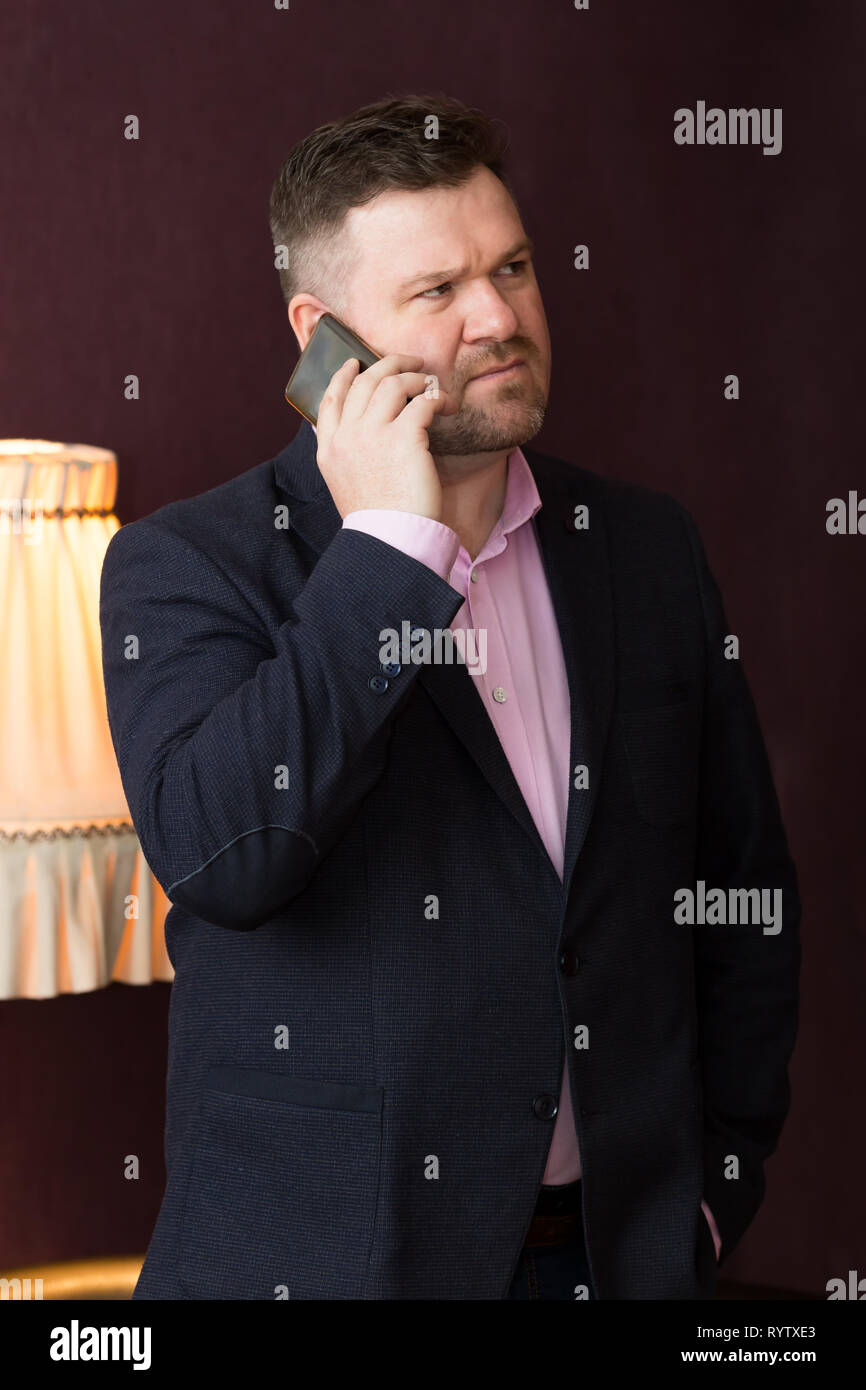 Fat man with a beard talking on a mobile phone Stock Photo - Alamy