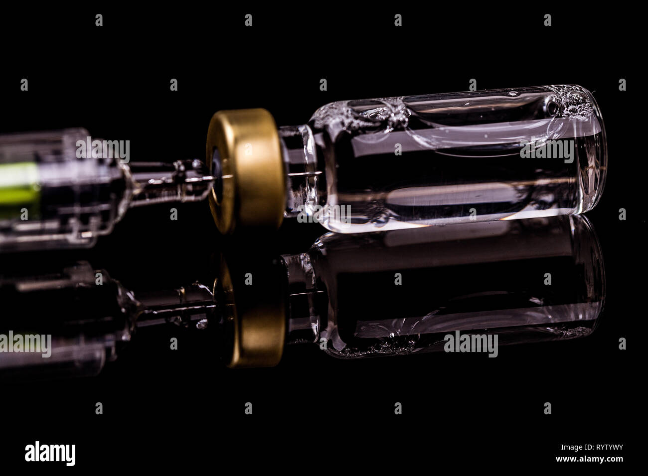 Medical vials for injection with a syringe and ampules on black ...