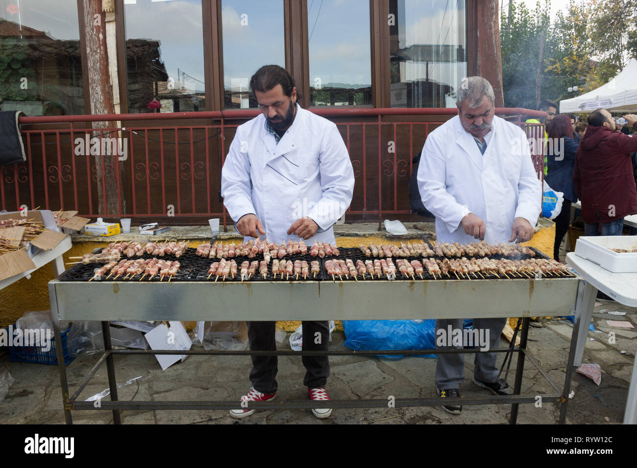 Greek traditional fresh raw pork meat souvlaki wooden skewers charred ...