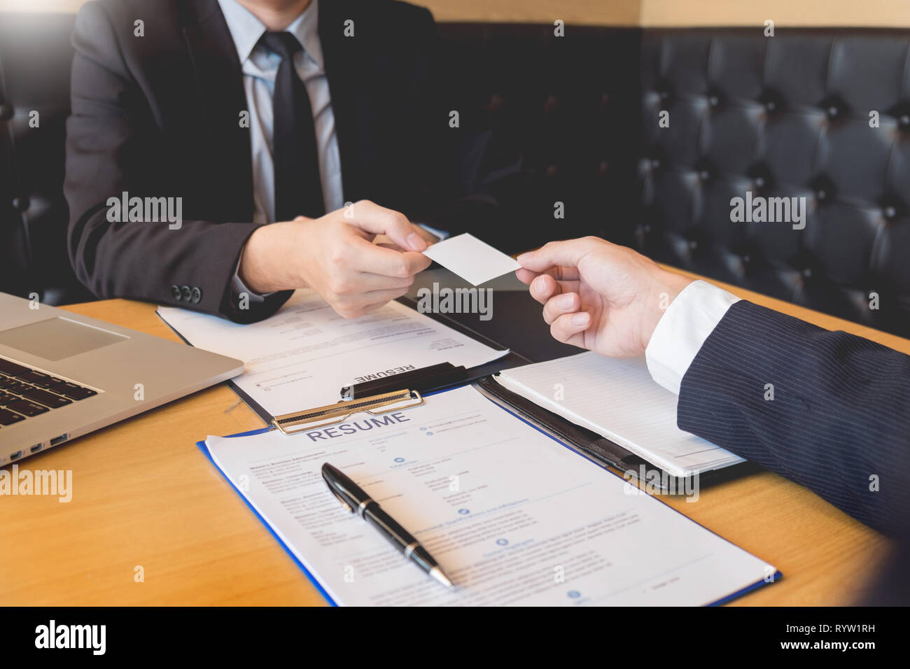 businessman listen to young attractive man explaining about his profile ...