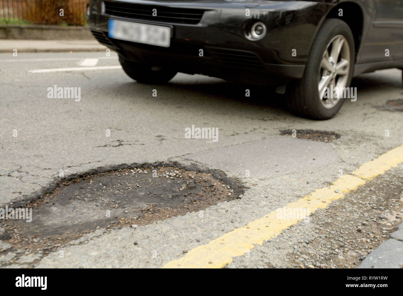 Potholes on a residential street. Wandsworth, South London. 25.03.2010 ...