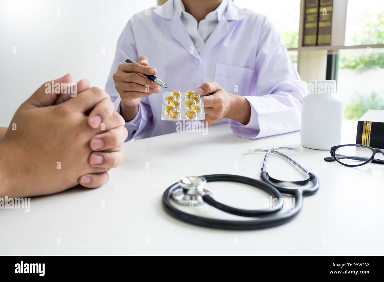 doctor hand holding tablet of drug and explain to patient in hospital ...