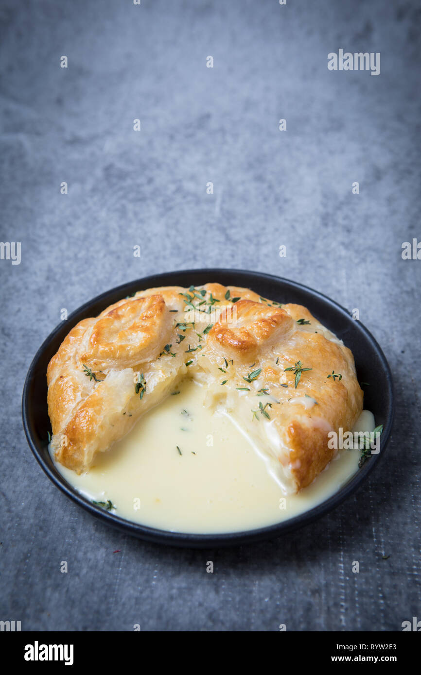 Oozing camembert en croute. Melted camembert with crusted puff pasty ...