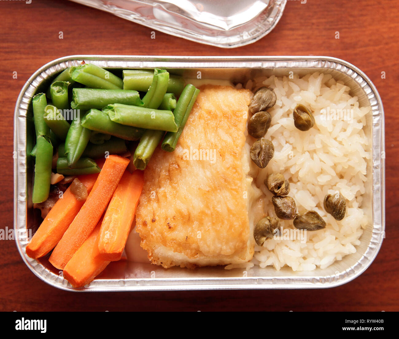 Fish and rice - inflight meal, shot on wooden surface Stock Photo - Alamy