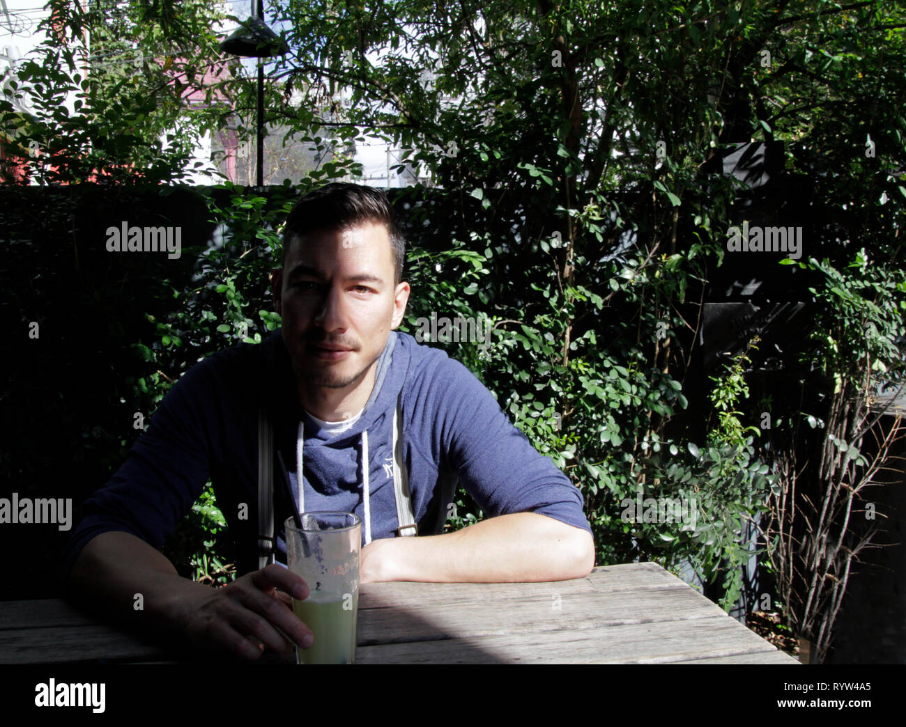 Portrait of a handsome young man with a shadow covering half his face ...