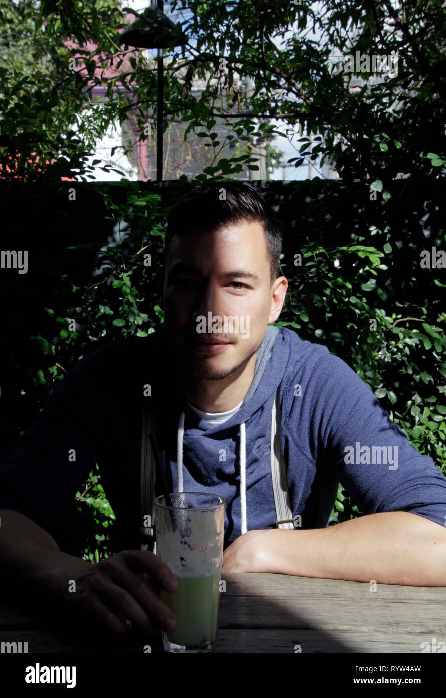 Portrait of a handsome young man with a shadow covering half his face ...