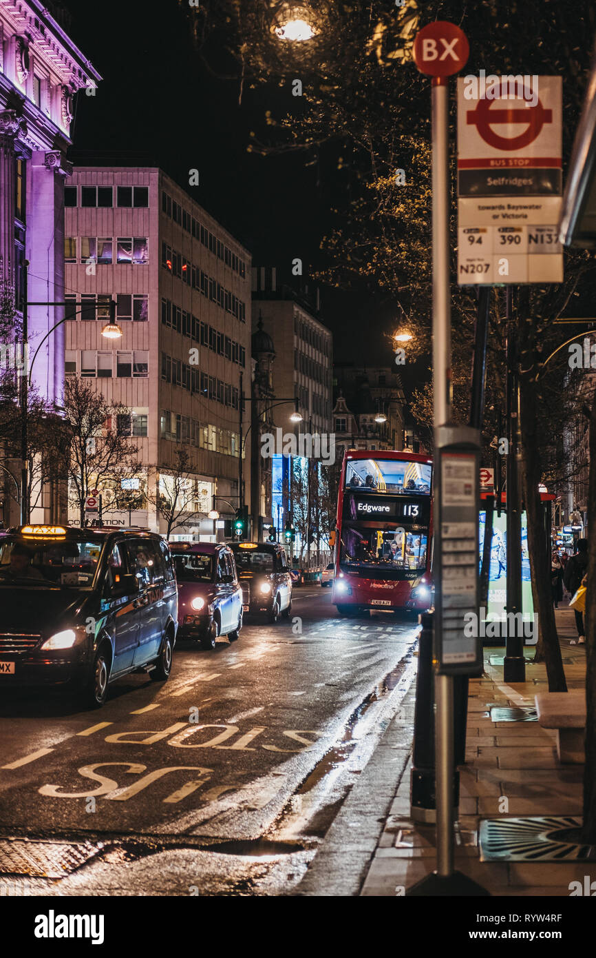 London UK March 9 2019 Red Double Decker Bus Approaching Bus Stop On Oxford Street London london-uk-march-9-2019-red-double-decker-bus-approaching-bus-stop-on-oxford-street-london