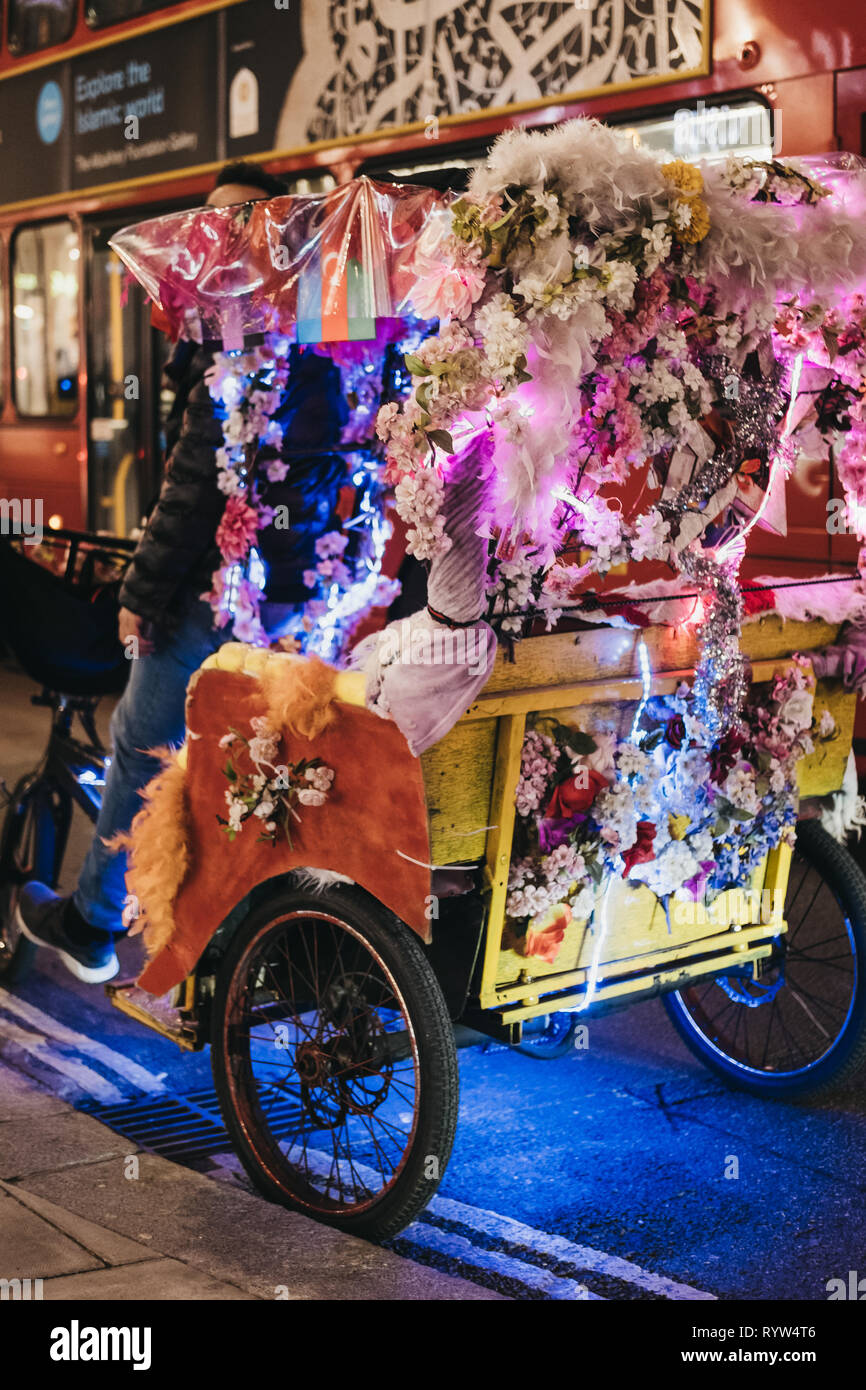 London, UK - March 9, 2019: Colourful rickshaws decorated with flowers ...