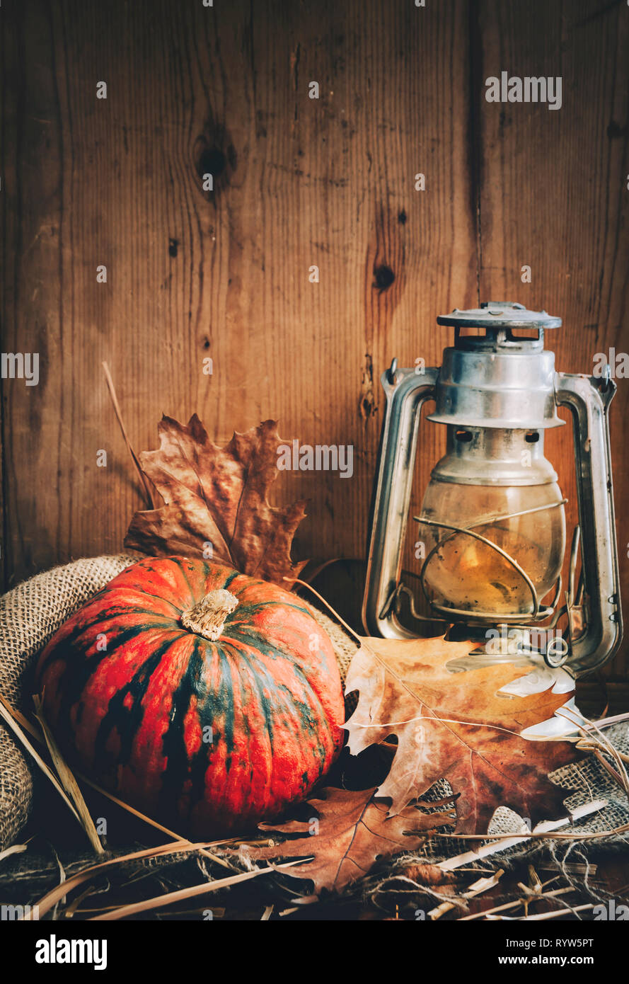 Still life with halloween pumpkin and vintage lantern on rustic wooden ...