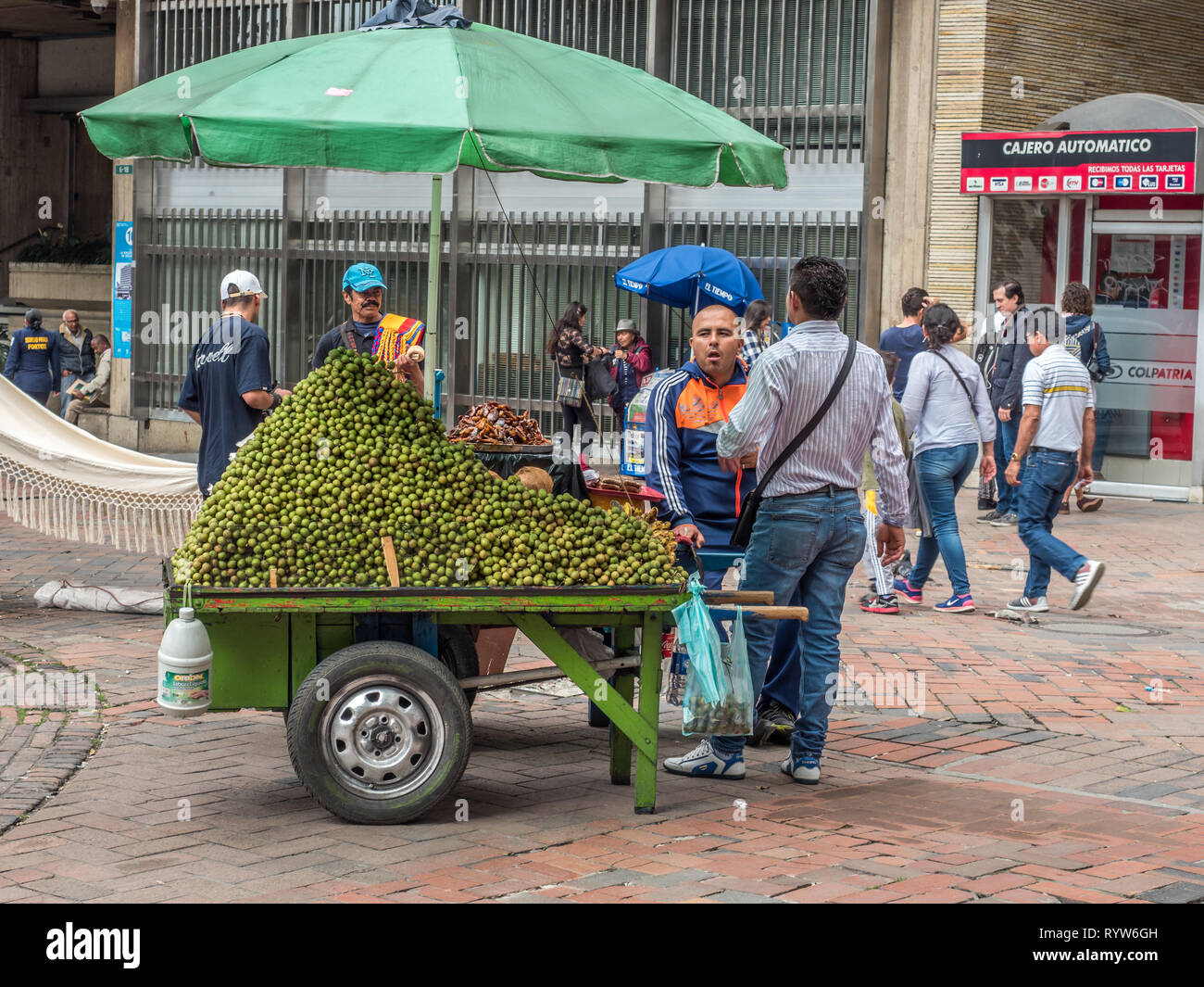 Bogota, Colombia - November 23, 2018: Man selling small green fruit on ...