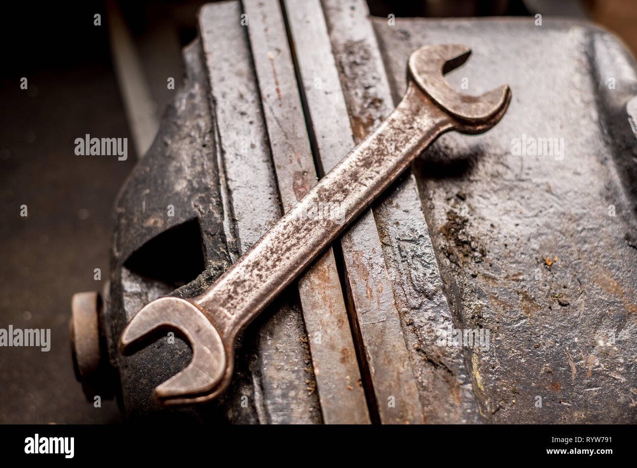 Old vintage spanner on a big iron vice isolated Stock Photo - Alamy