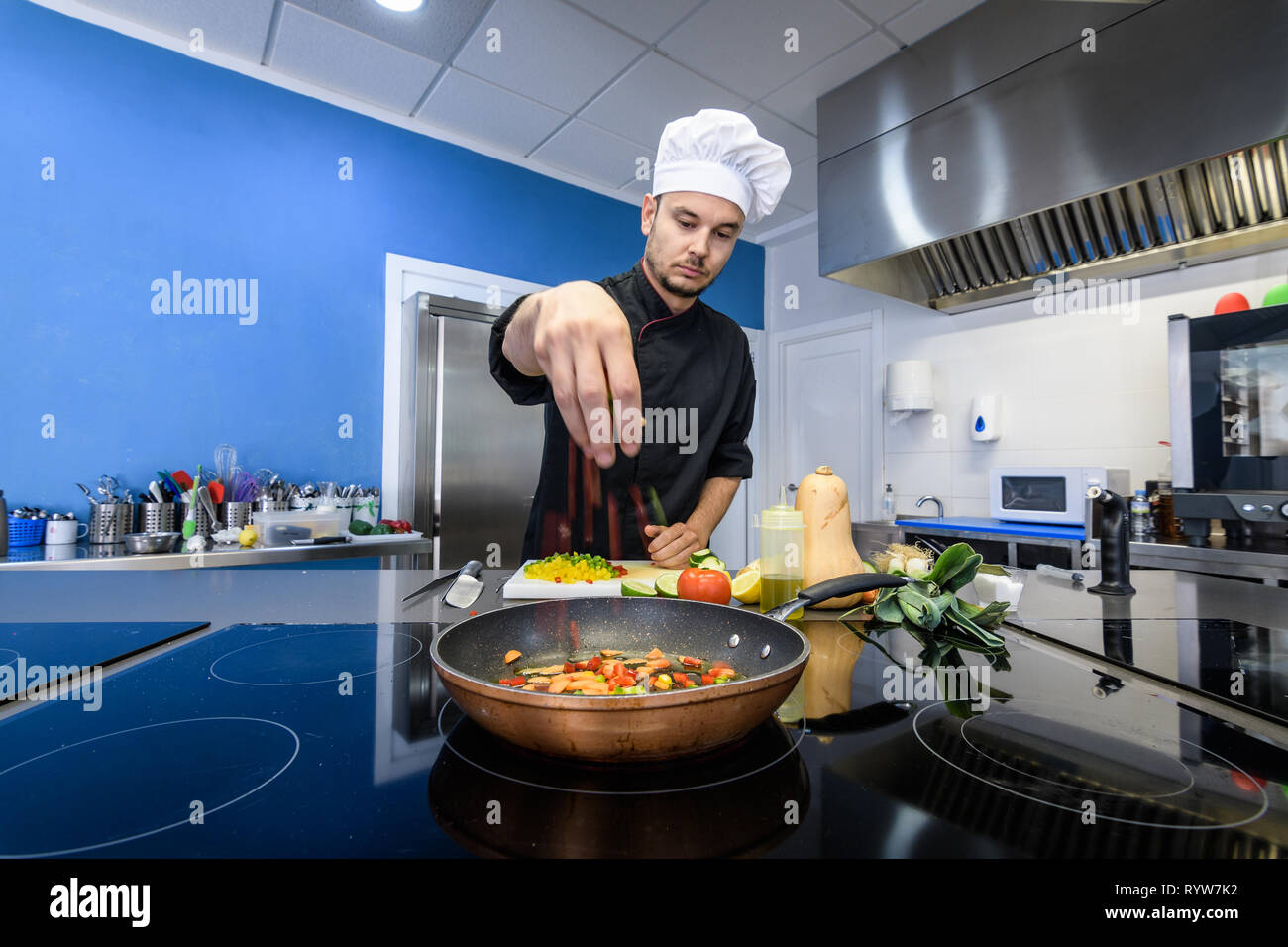 Adding vegetables in a frying pan hi-res stock photography and images ...