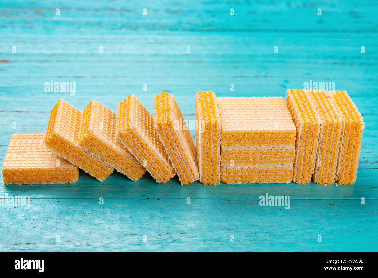 sdie view cheese wafer blocks on blue background Stock Photo - Alamy