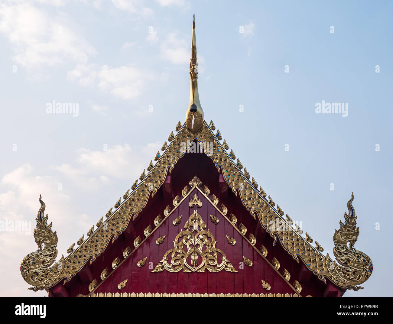 Carved floral pattern in the traditional Thai style on the gable of the ...