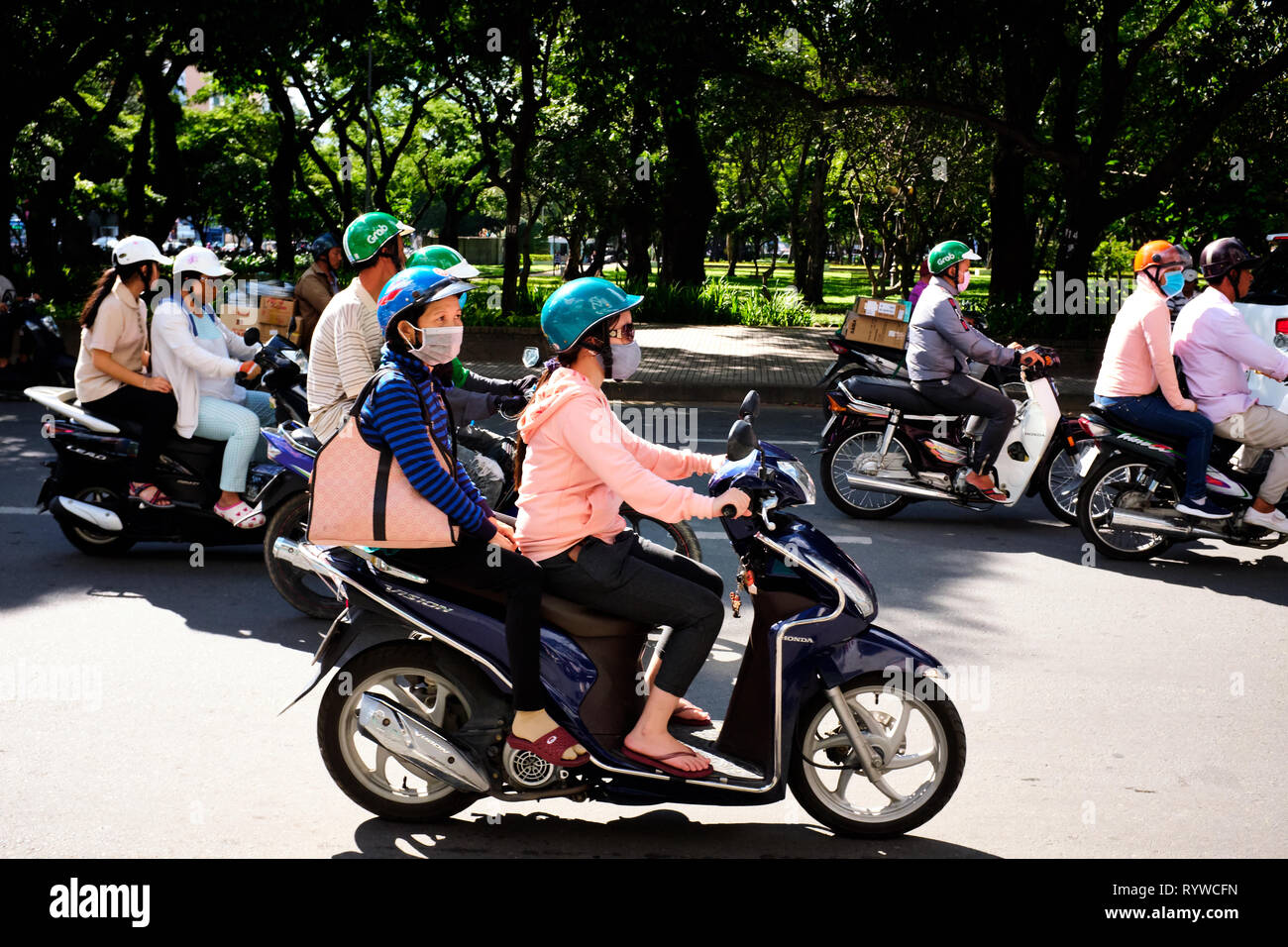 Pictured are Vietnamese on scooters during rush hour at Ho Chi Min City ...