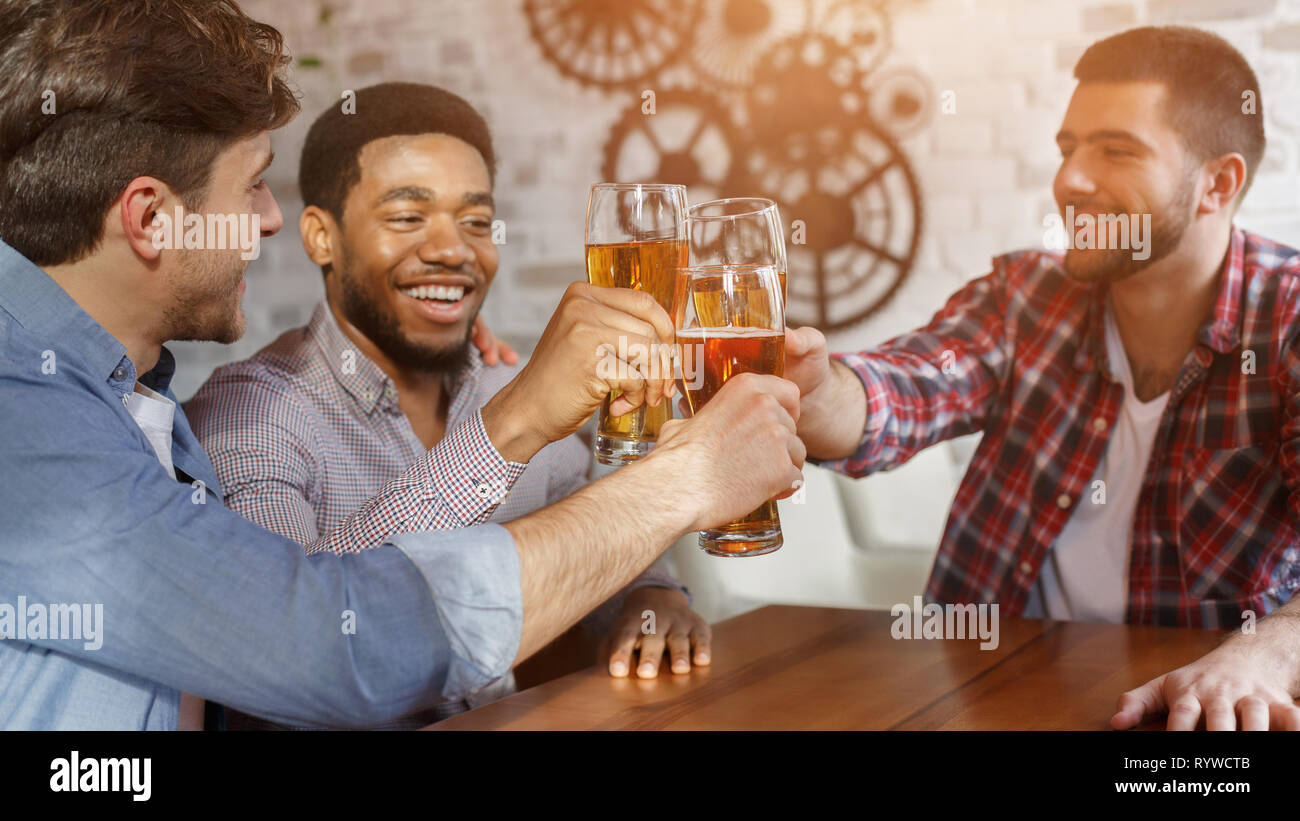 Best friends celebrating meeting, drinking beer in bar Stock Photo - Alamy