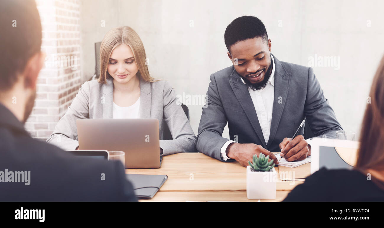 Managers working in office, using laptop and writing ideas Stock Photo ...
