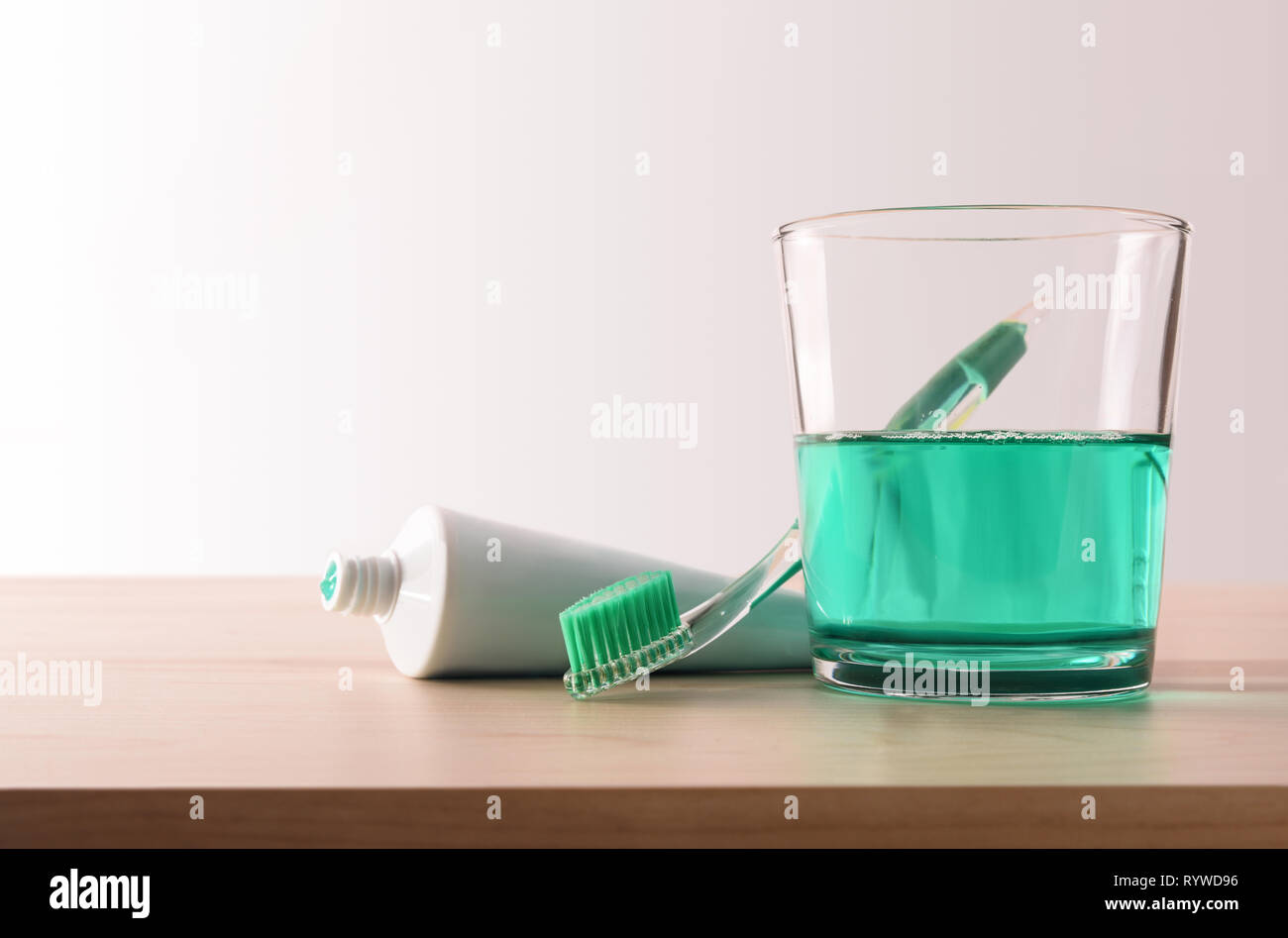 Toothbrush toothpaste and mouthwash on the wooden table. Horizontal ...