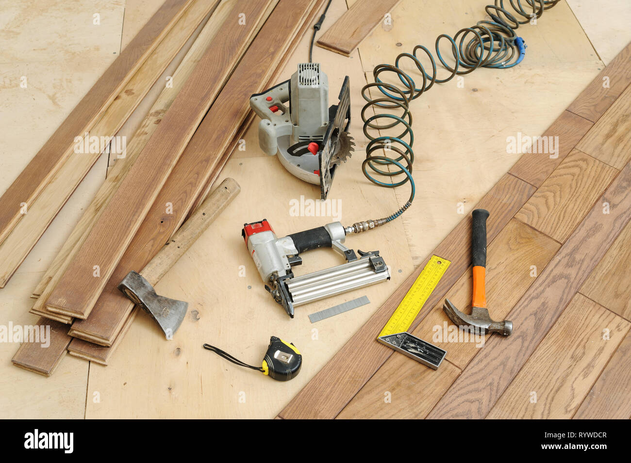 Installing a wooden floor. Carpenter's tools on the floor Stock Photo ...