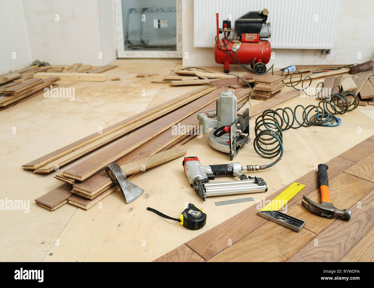 Installing a wooden floor. Carpenter's tools on the floor Stock Photo ...