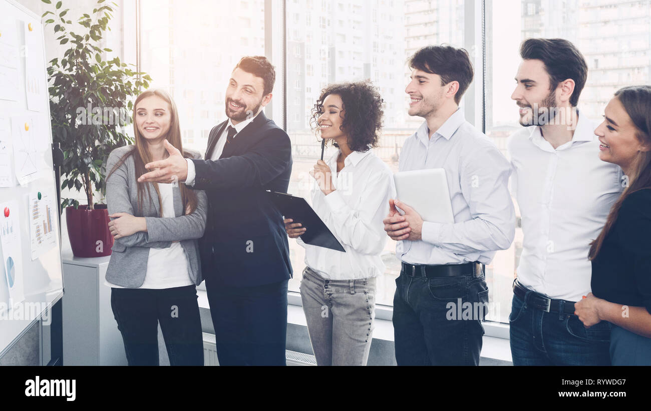 Business team discussing project together, looking at graphics Stock ...