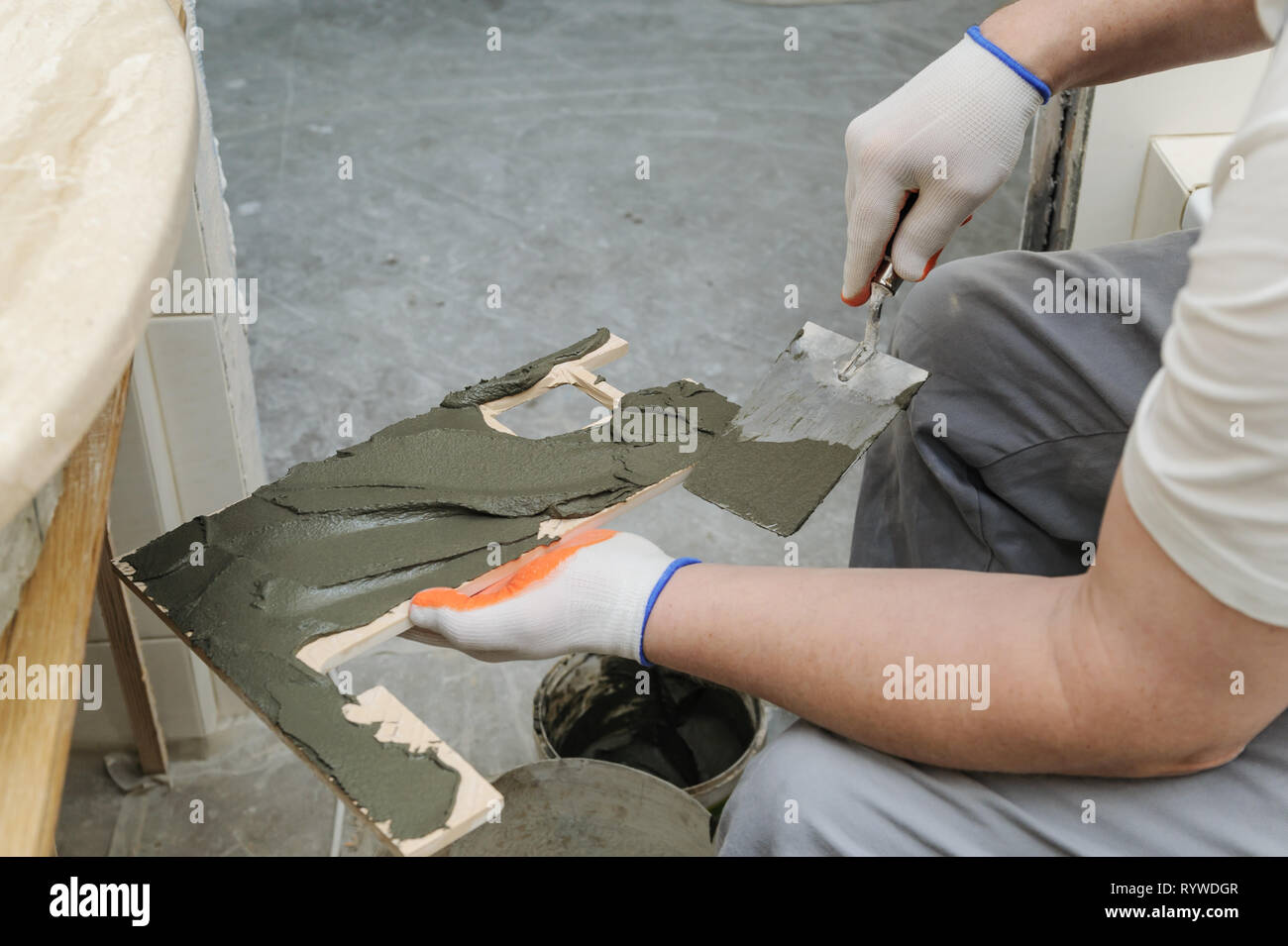 Worker with tile adhesive hi-res stock photography and images - Alamy