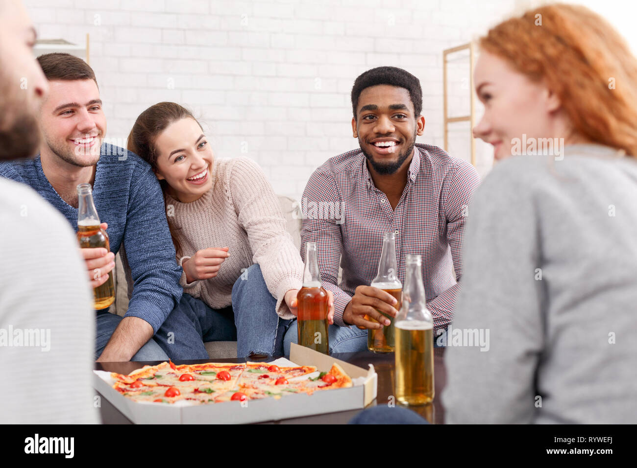 Friends talking, eating pizza and drinking beer Stock Photo - Alamy