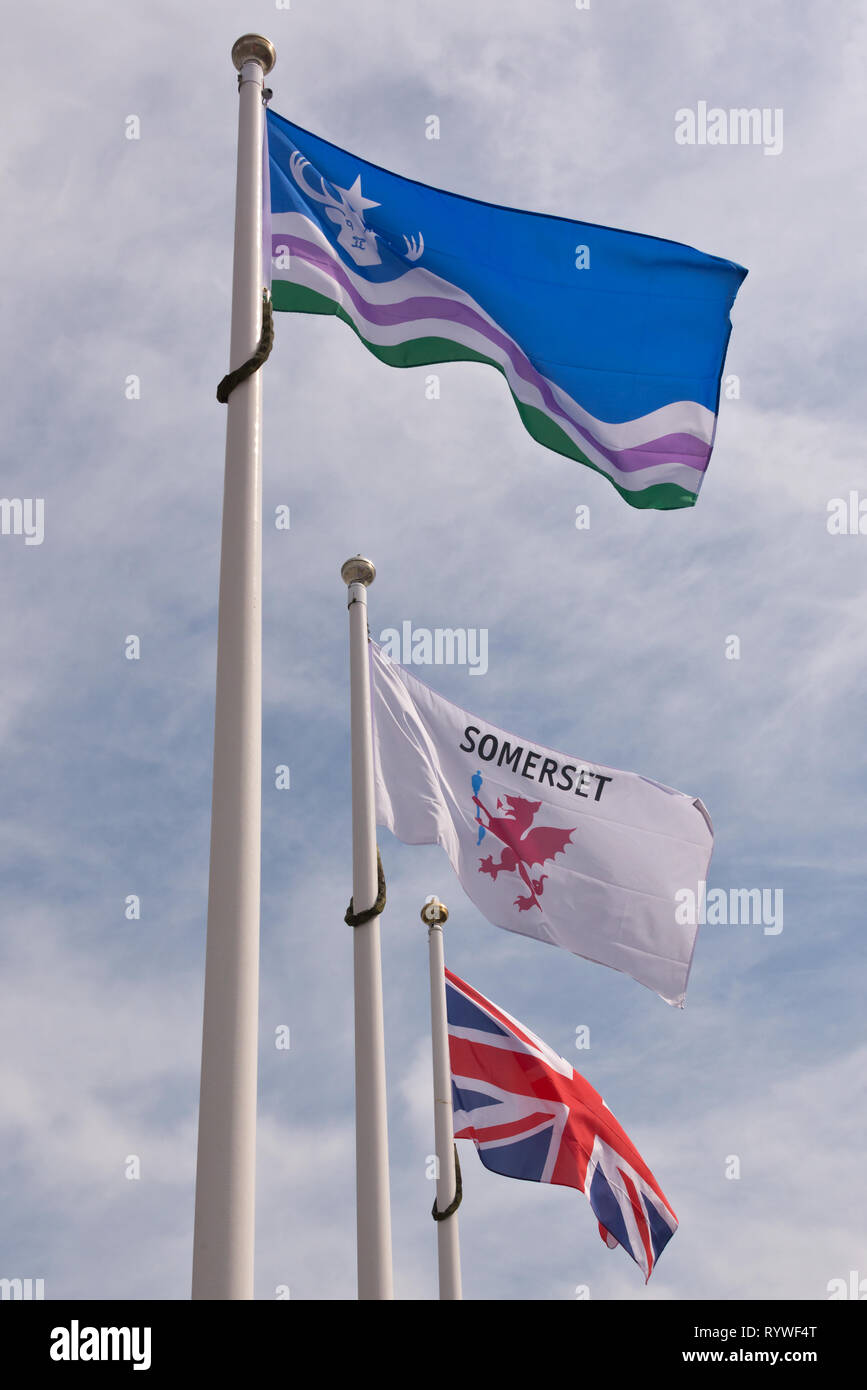 Union Jacks, Exmoor flag and Somerset flag against a light cloudy sky ...