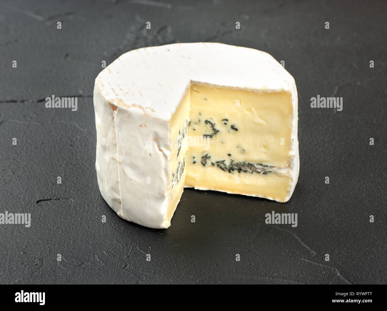 Piece brie cheese with mold on dark background Stock Photo - Alamy
