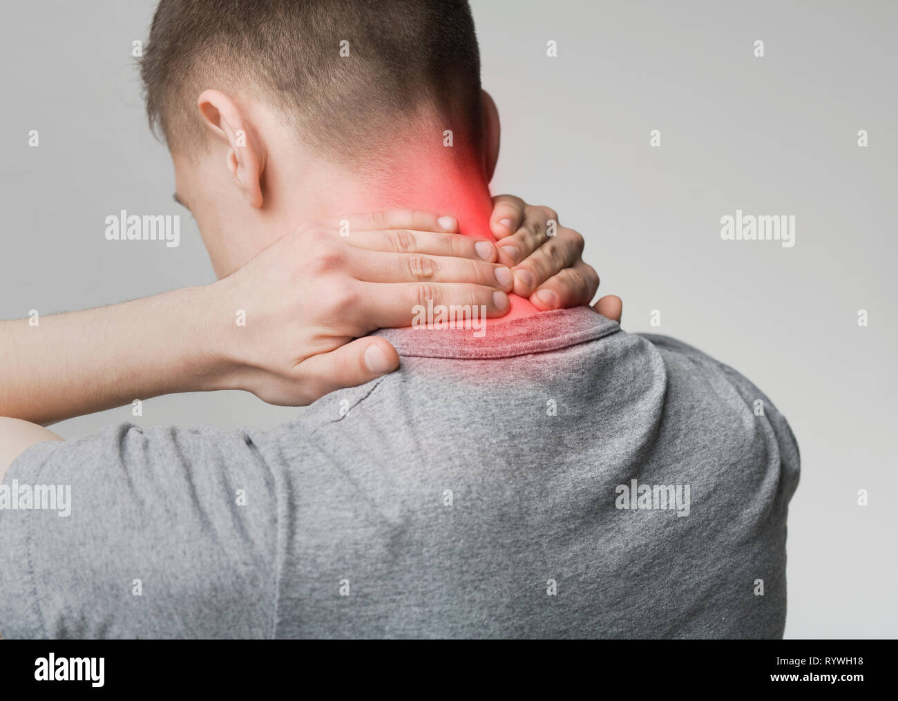 Strong man with neck pain, back view Stock Photo - Alamy
