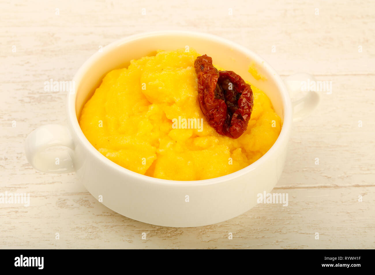 Polenta with dry tomato Stock Photo - Alamy