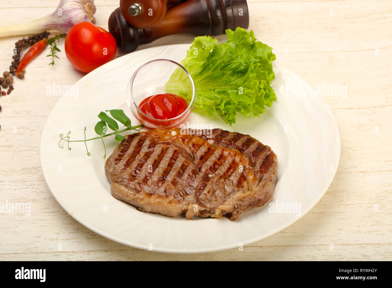 Grilled Rib eye steak with sauce Stock Photo - Alamy