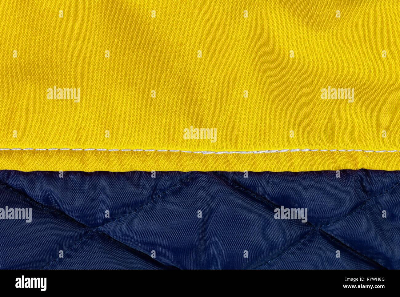 Detail of a portion of the inner side of a yellow and blue down jacket ...