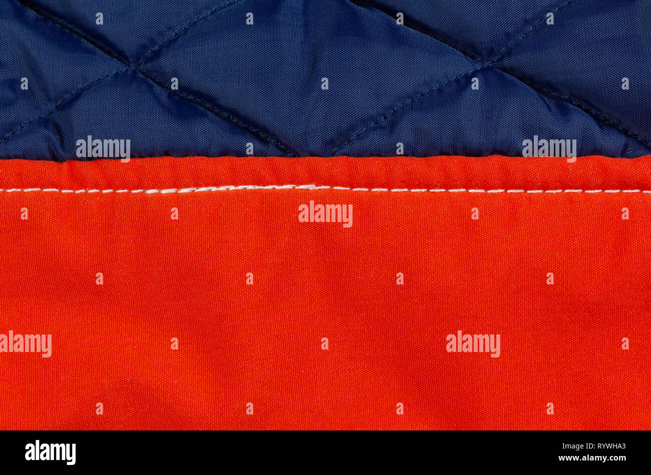 Detail of a portion of the inner side of a red and blue down jacket ...