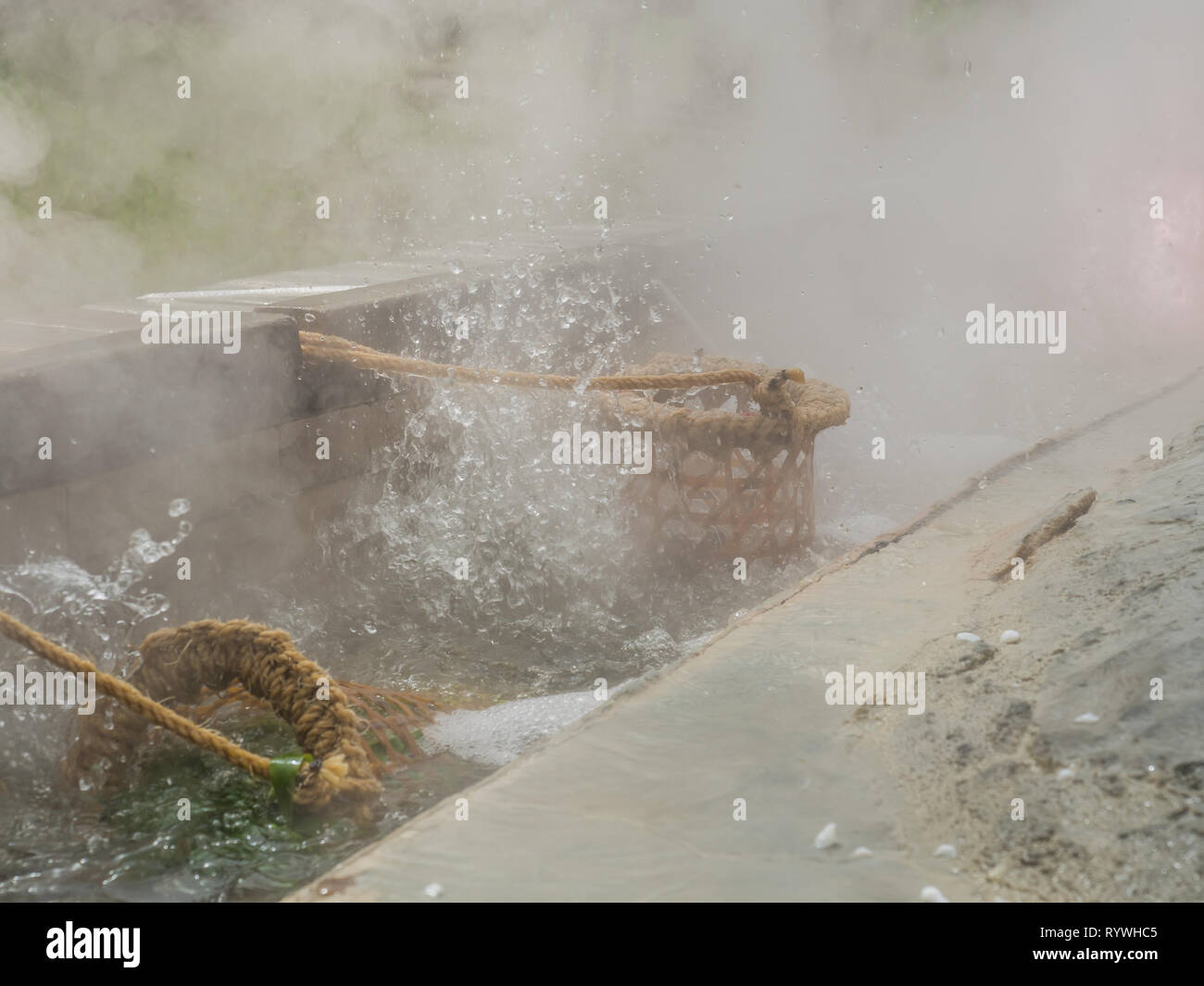 Eggs and vegetables being cooked in the water of hot springs in Taiping ...