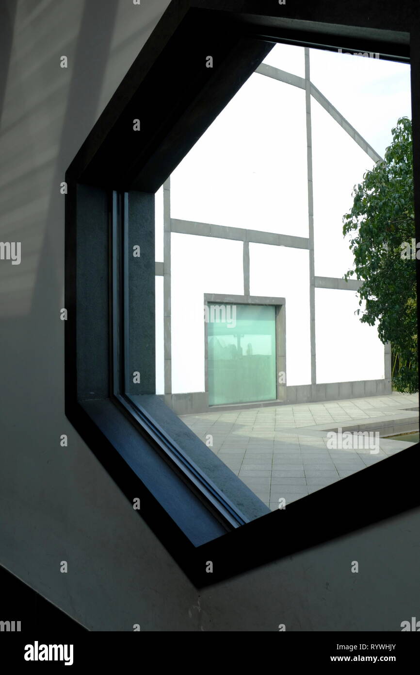 Window of Suzhou Museum with view of museum garden.Suzhou Museum was ...