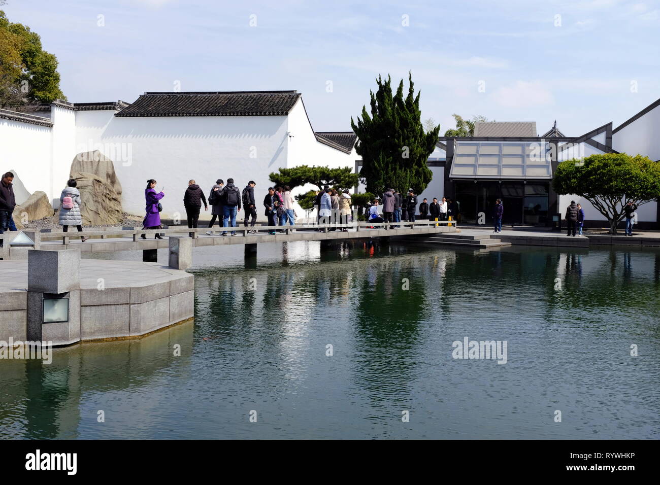 Visitors in the garden of Suzhou Museum with reflecting pool and ...