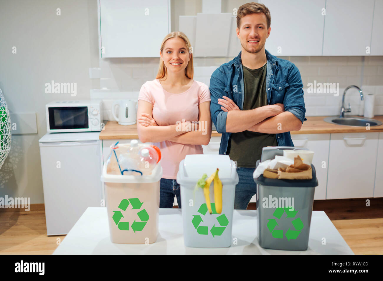 Waste sorting at home. Protect the environment. Young happy family put ...
